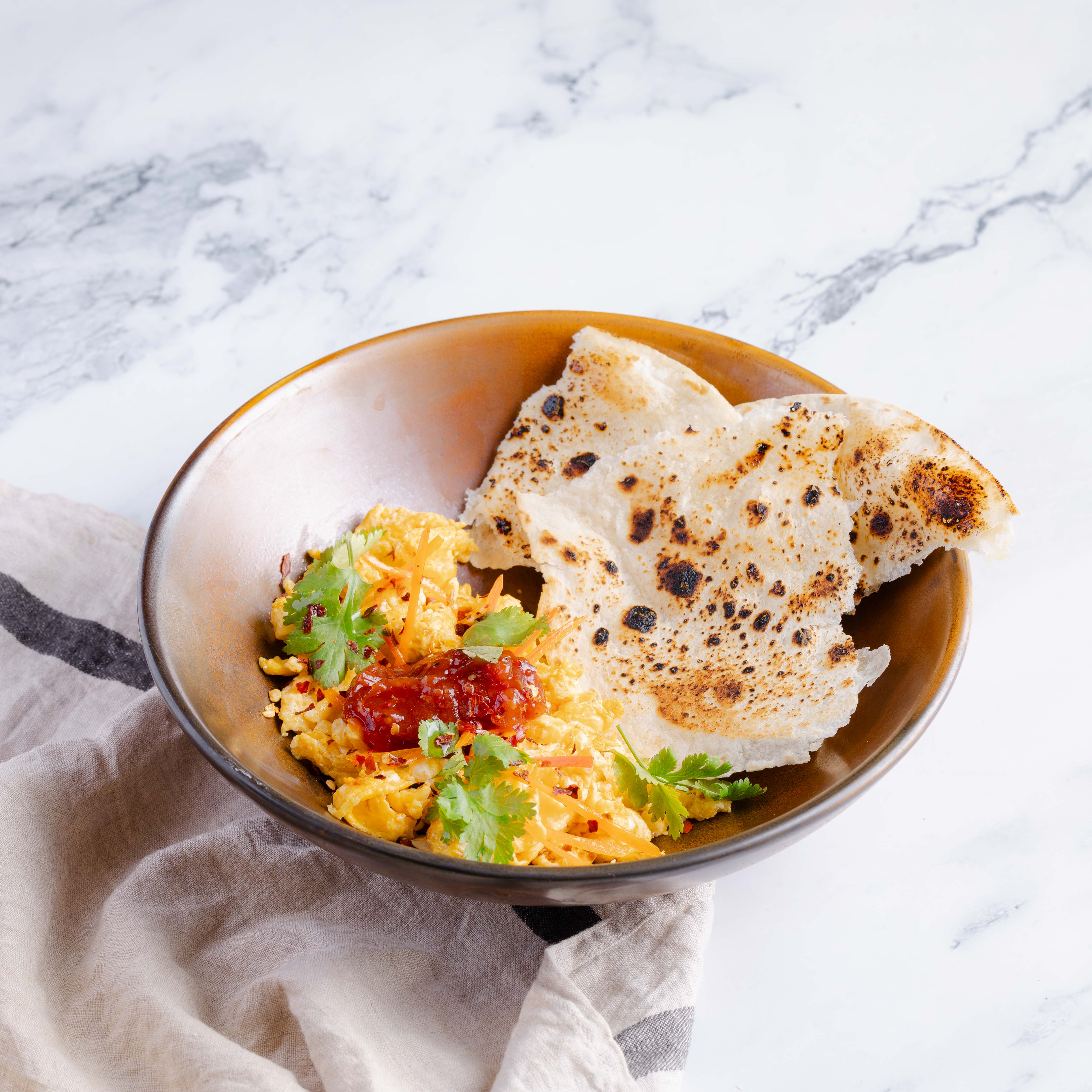 Turmeric spiced colonial scrambled eggs, roti and tomato chutney (v)
